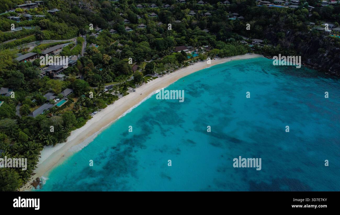 Expansive View of a Secluded Tropical Cove with Resort Villas and Clear ...