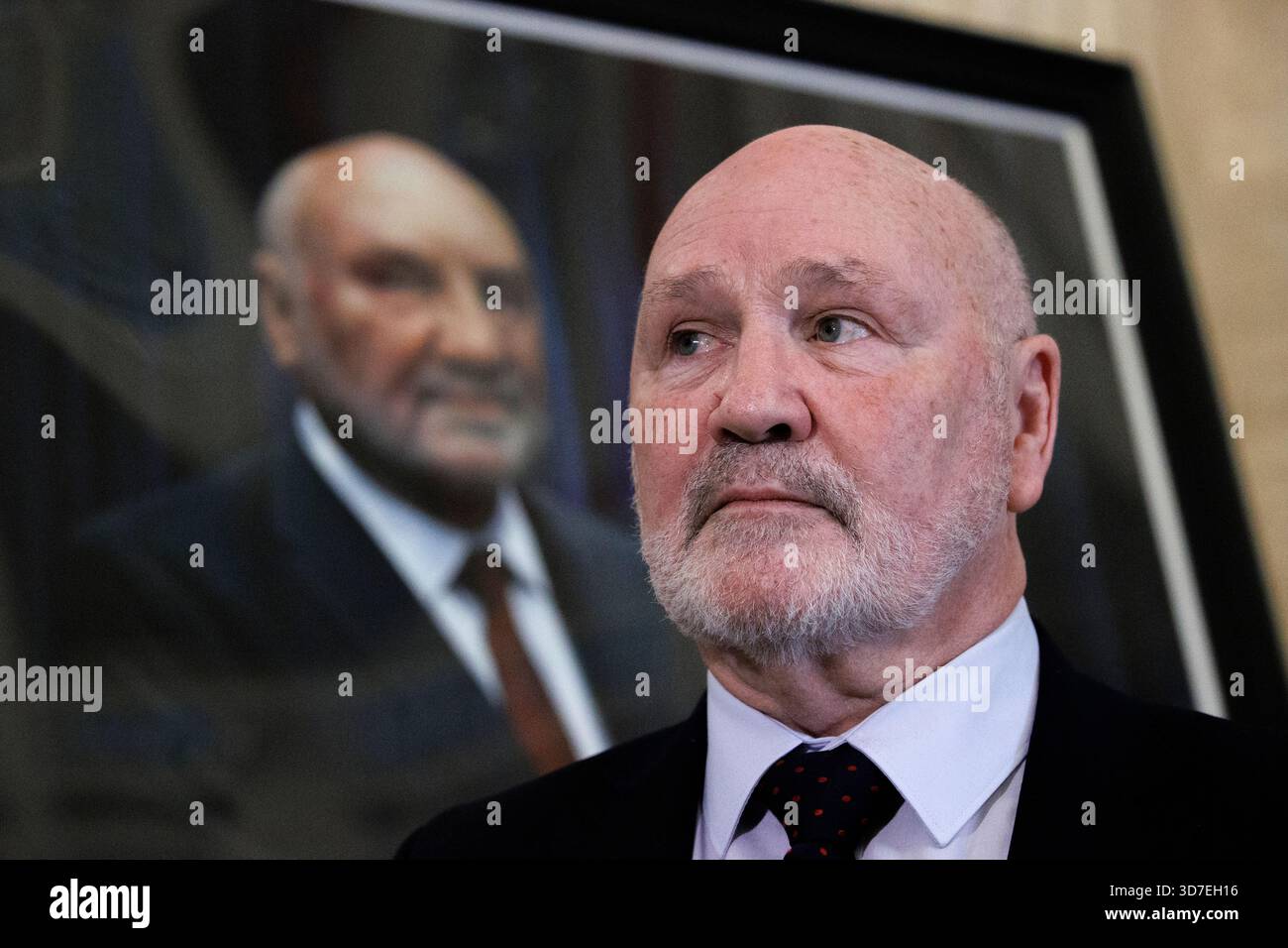 Former Stormont speaker Alex Maskey in front of a portrait of him by ...