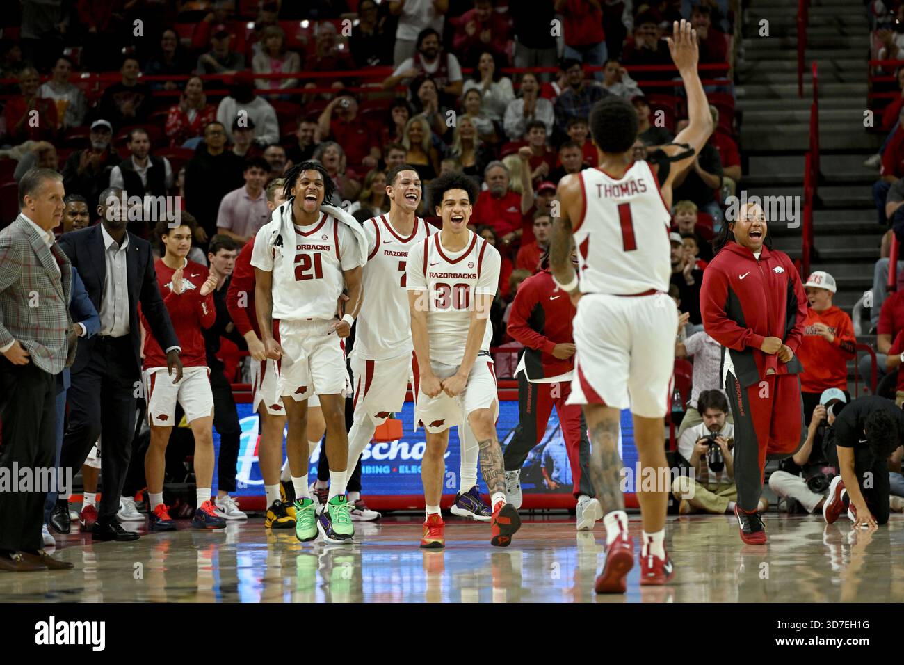 Arkansas players D.J. Wagner (21), Trevon Brazile (7), Isaiah Sealy (30 ...