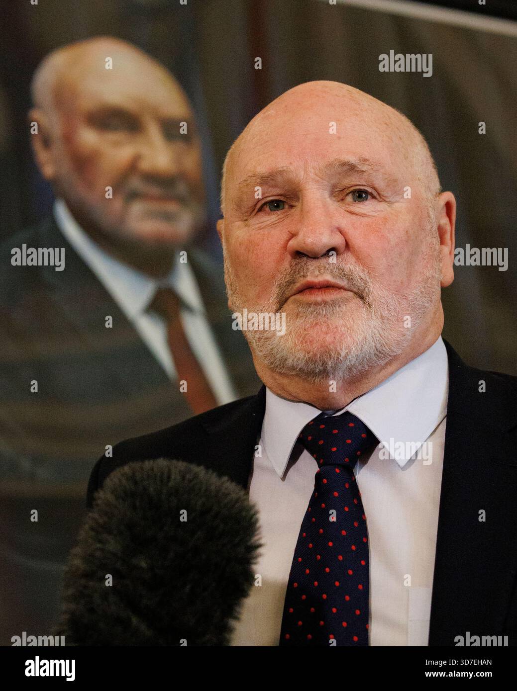 Former Stormont speaker Alex Maskey in front of a portrait of him by ...