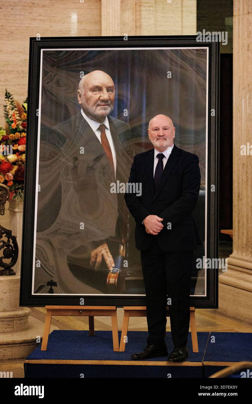 Former Stormont speaker Alex Maskey in front of a portrait of him by ...