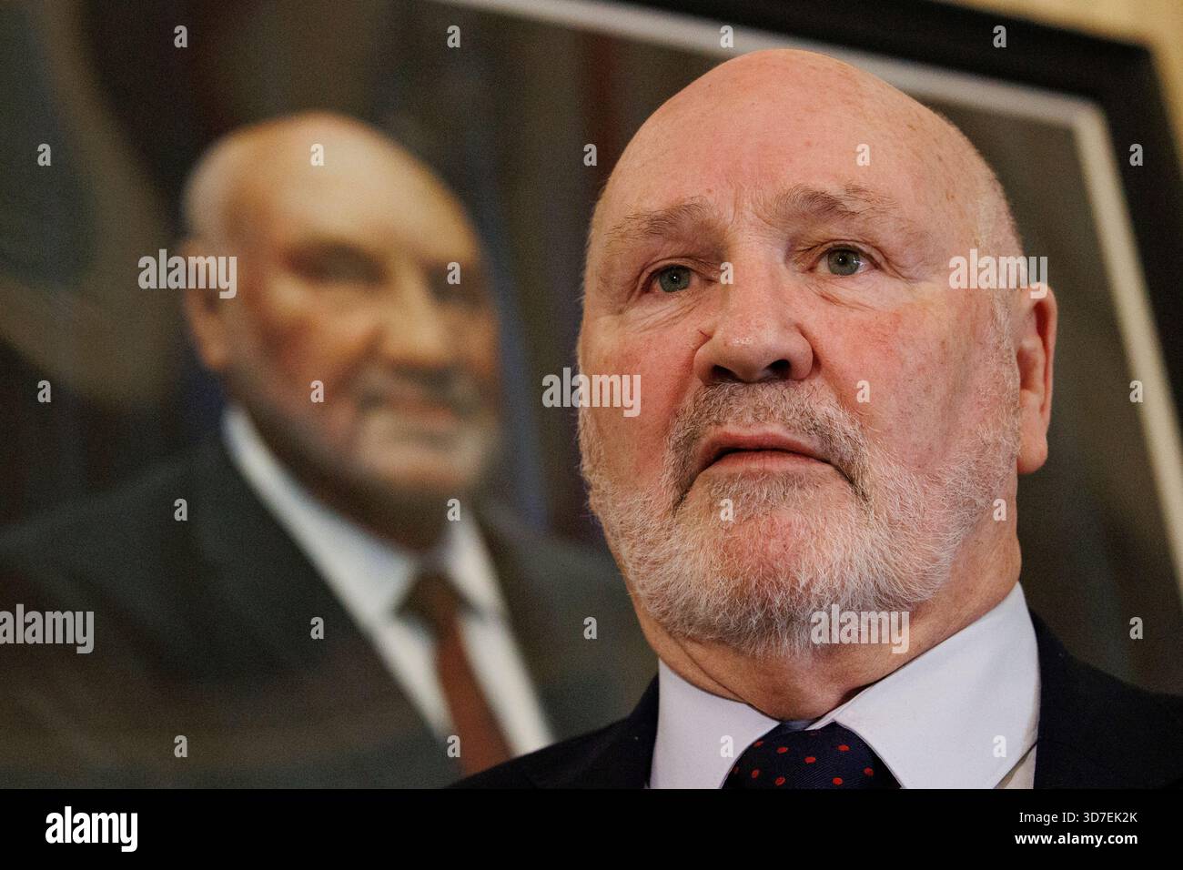 Former Stormont speaker Alex Maskey in front of a portrait of him by ...