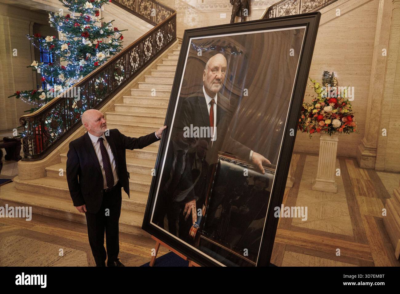Former Stormont speaker Alex Maskey in front of a portrait of him by ...