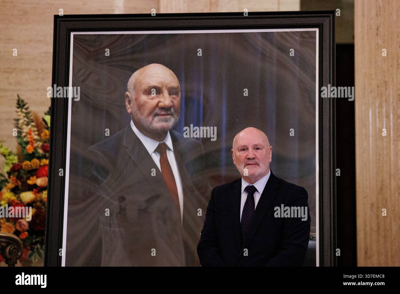 Former Stormont speaker Alex Maskey in front of a portrait of him by ...