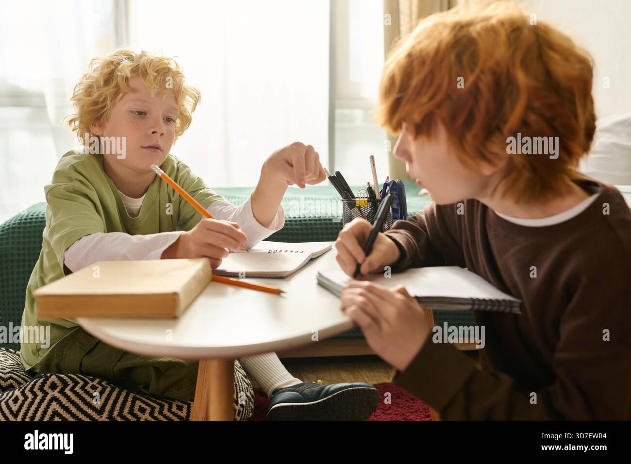 Two boys engage in drawing and planning ideas in their modern living ...