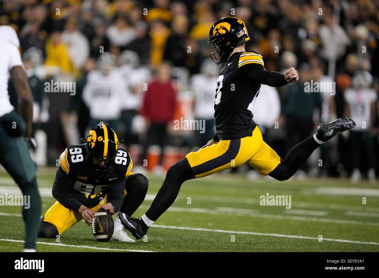 Iowa kicker Drew Stevens, right, kicks a field goal during the second ...