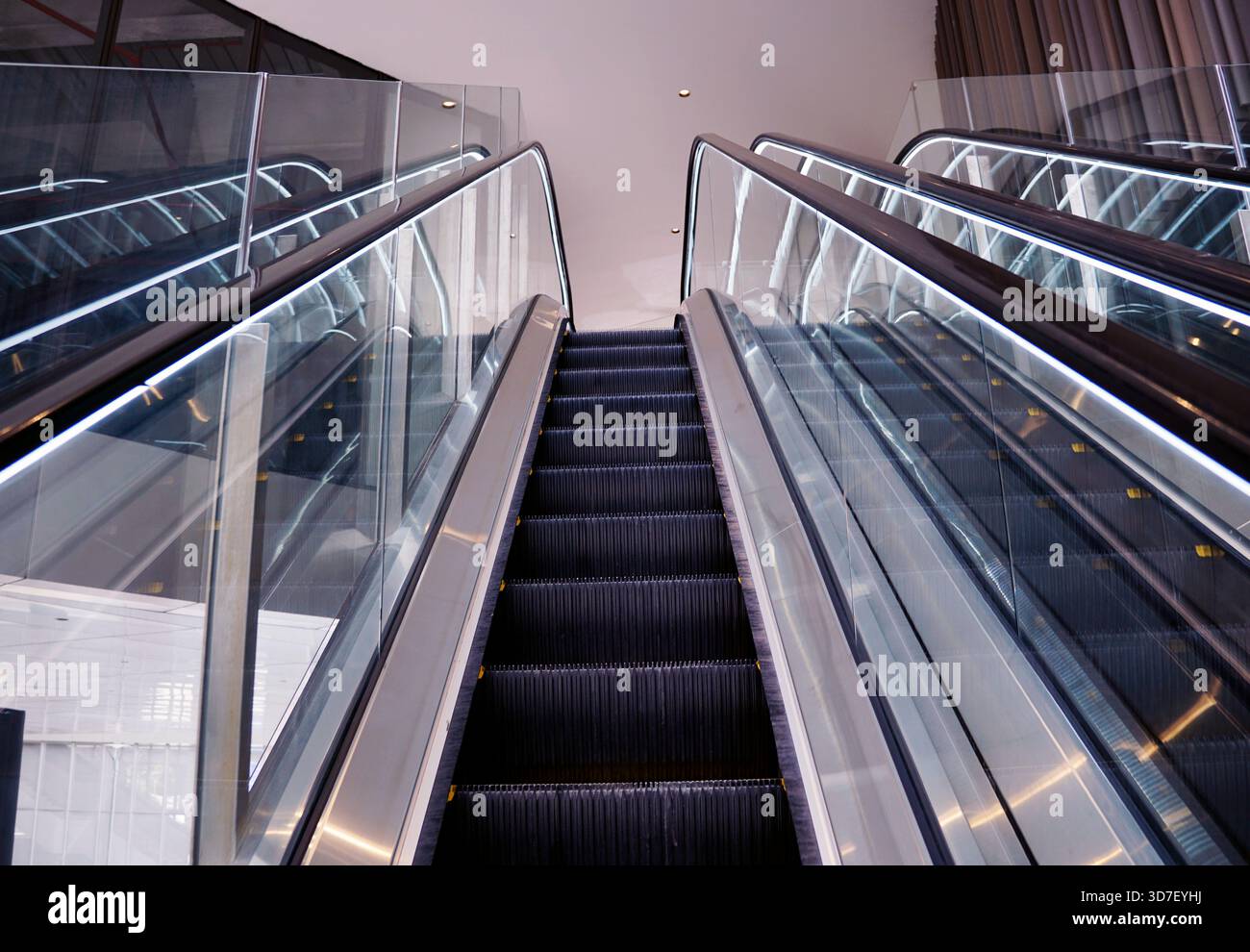 Empty escalator with led lighting on the sides at a shopping mall Stock ...