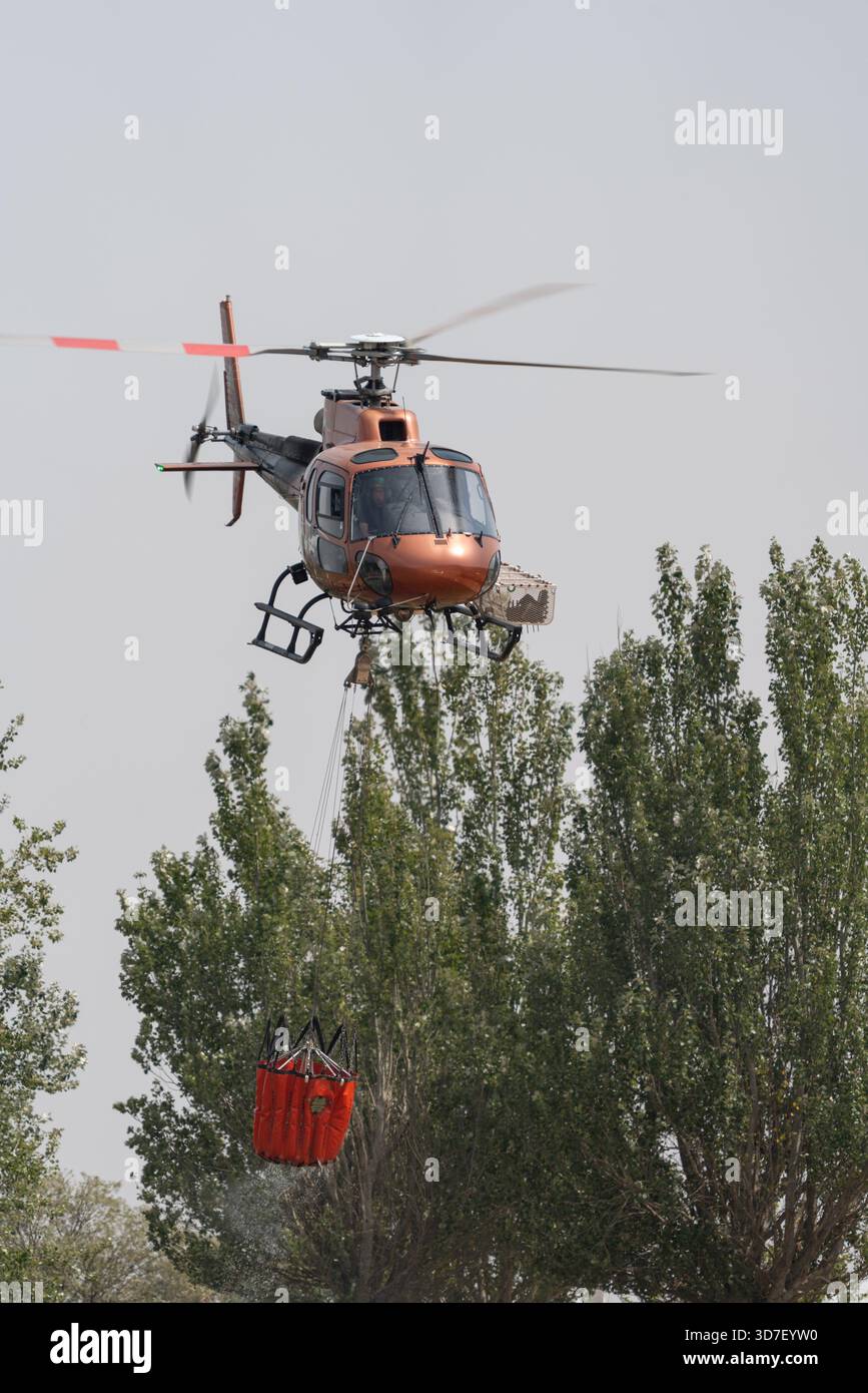Helicopter in Action Carrying Water Bucket for Firefighting Stock Photo ...