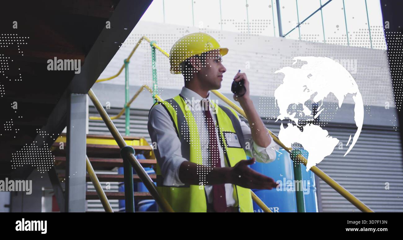 Gesturing supervisor wearing hard hat and safety vest speaking into ...