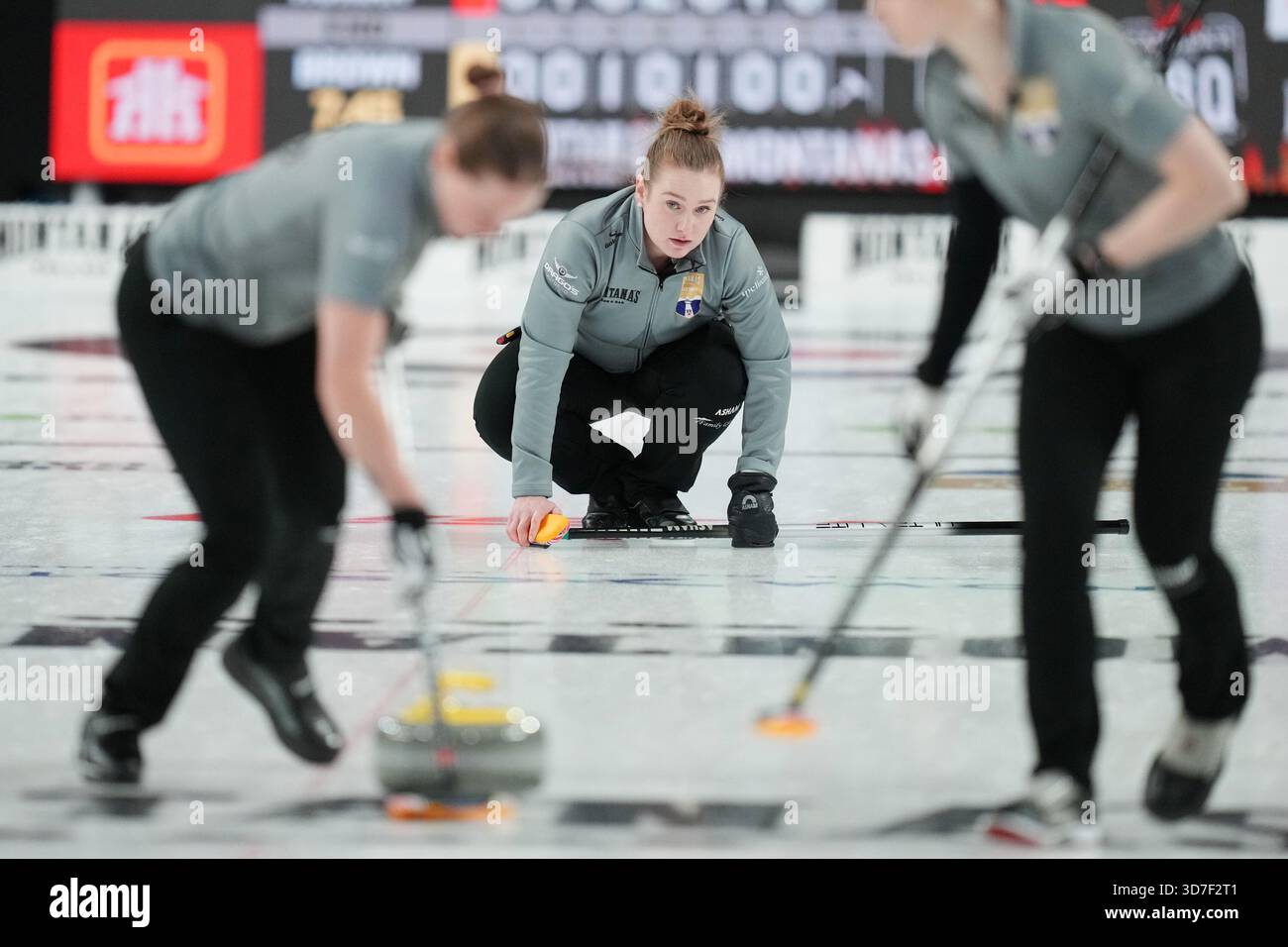 Corryn Brown, centre, watches teammates sweep a stone during Canadian ...