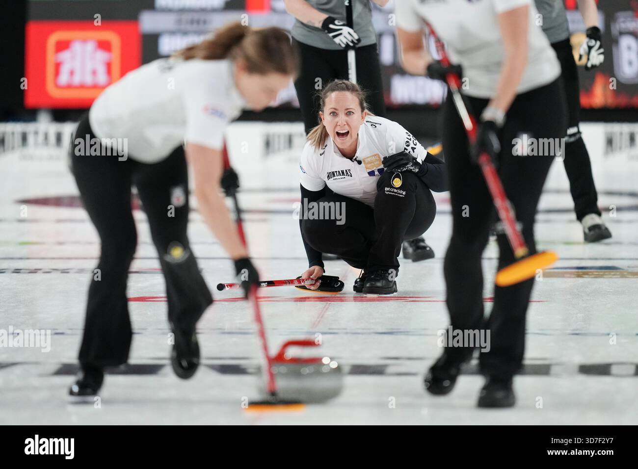 Rachel Homan yells directions to teammates after throwing a rock during ...