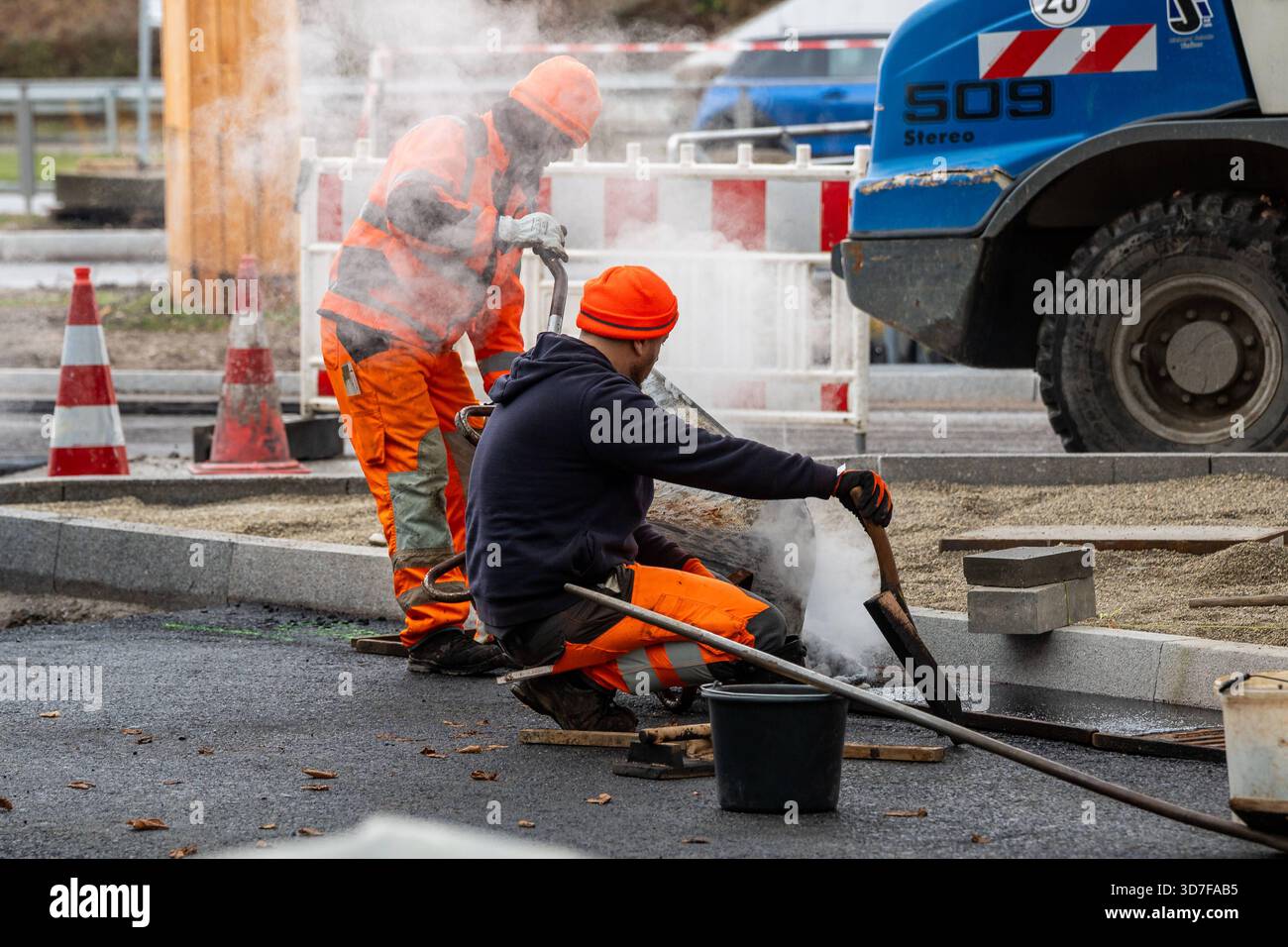 Bavaria, Germany - November 25, 2025: Construction workers pour hot ...