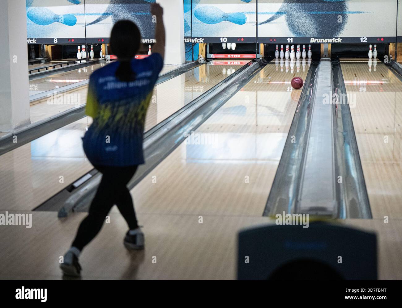 A contestant delivers the ball during the Strong Balls veteran bowling ...