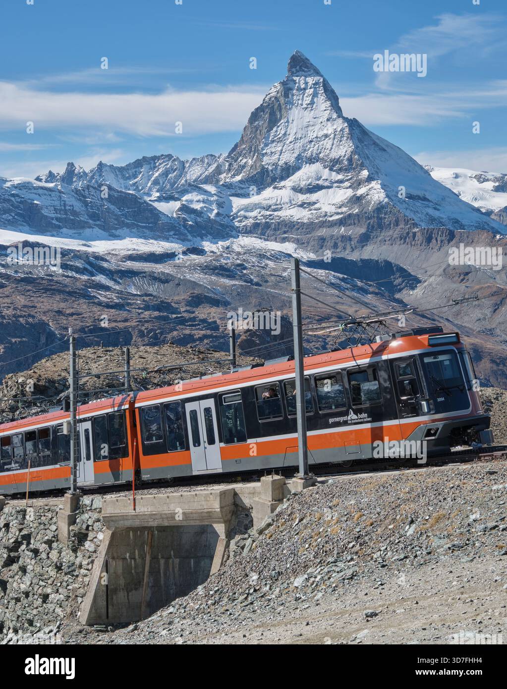 Red train approaching the Gornergrat summit Stock Photo - Alamy