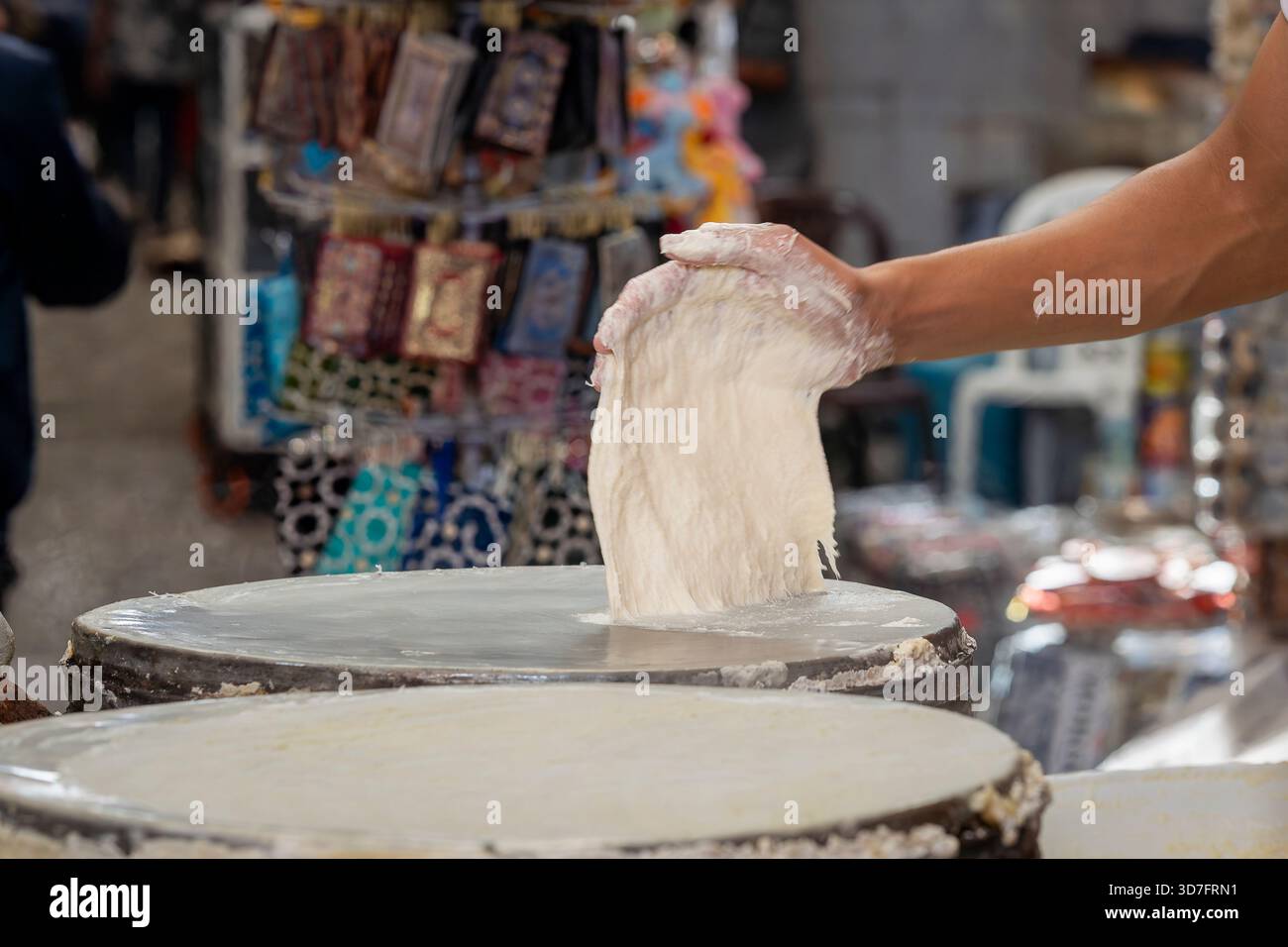 Skillful bastilla maker making bastilla sheets. Close-up of the ...
