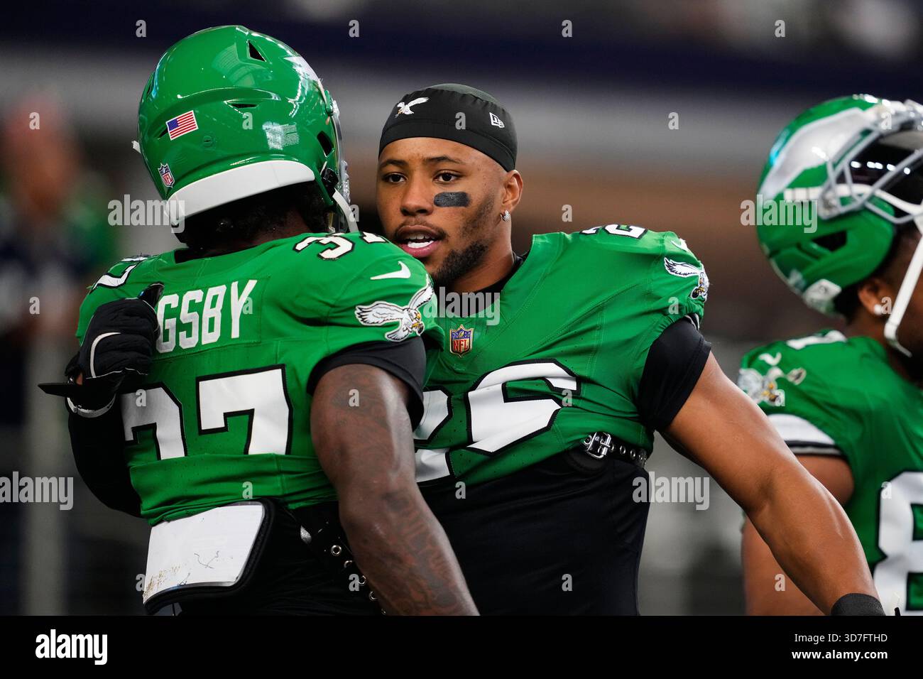 Philadelphia Eagles' Tank Bigsby (37) and Saquon Barkley, right, greet ...
