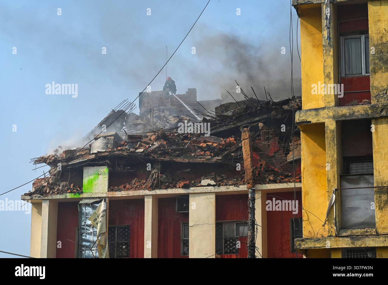 New Delhi, India - Nov. 25, 2025: Firemen try to douse the fire of a ...