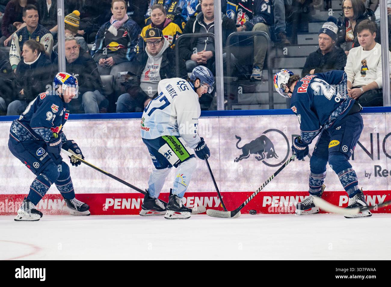 Fight for the puck by Maximilian Kastner (EHC Red Bull Munich, #93) and ...