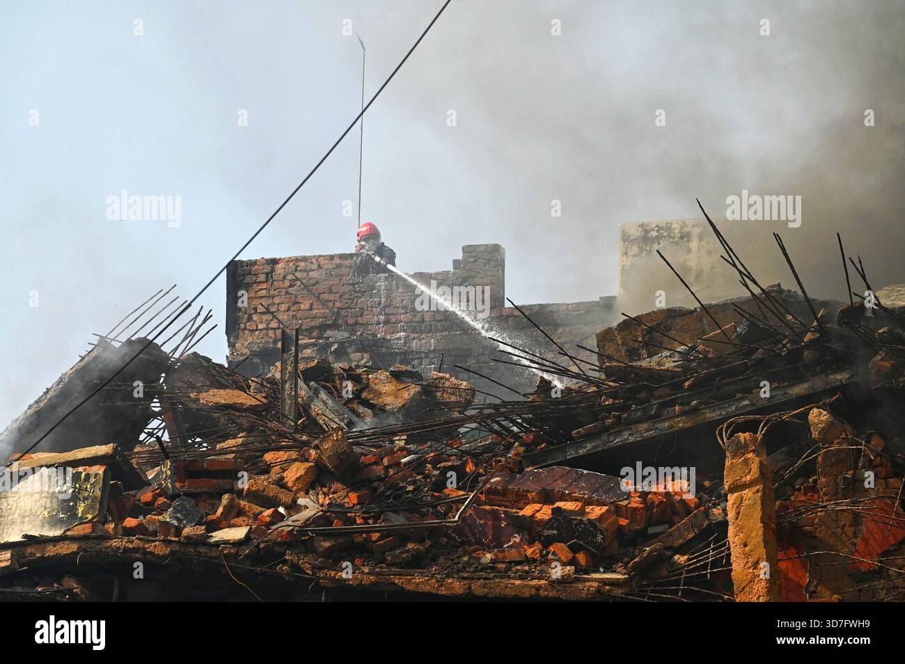 New Delhi, India - Nov. 25, 2025: Firemen try to douse the fire of a ...