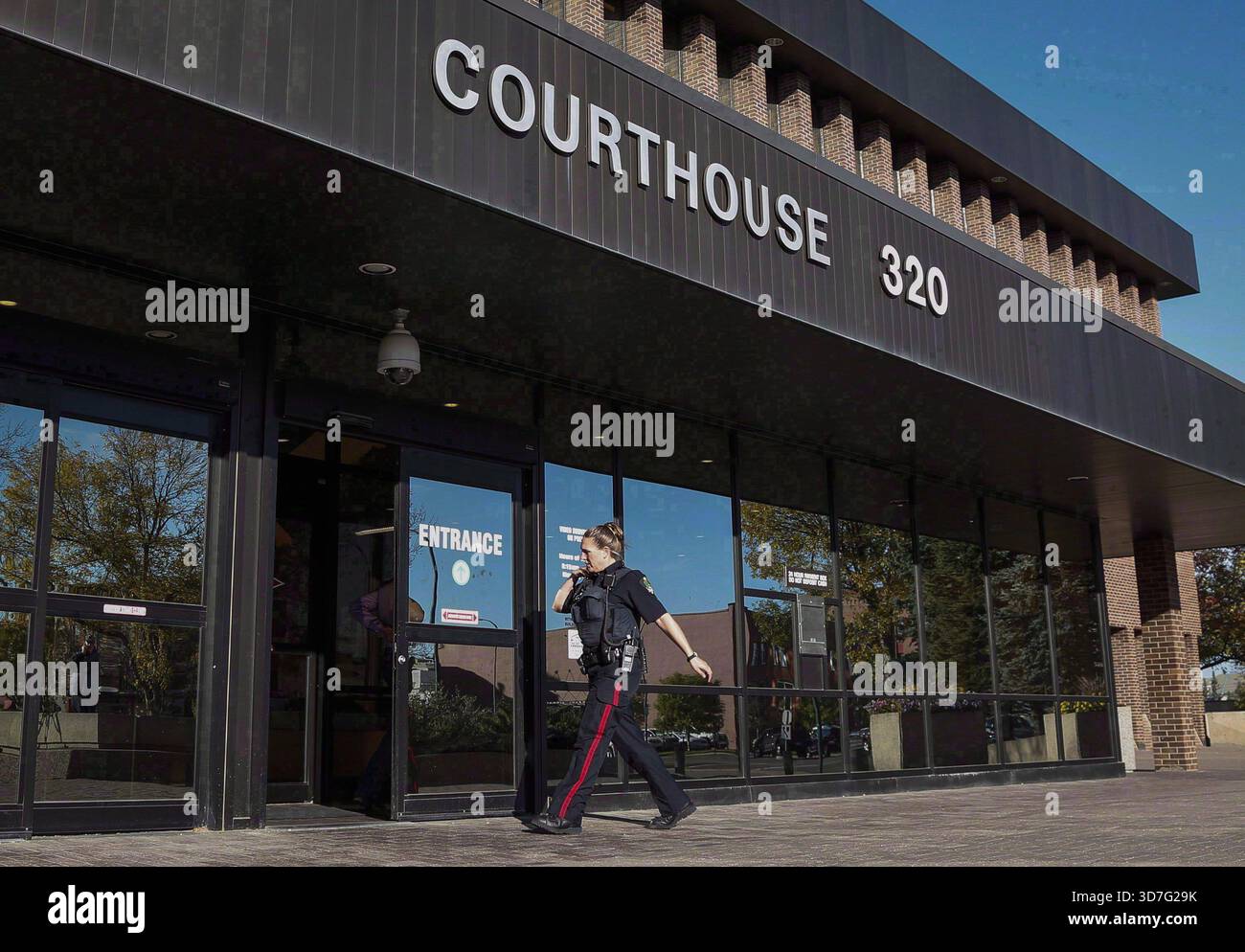 A police officer arrives at the provincial court building in Lethbridge ...