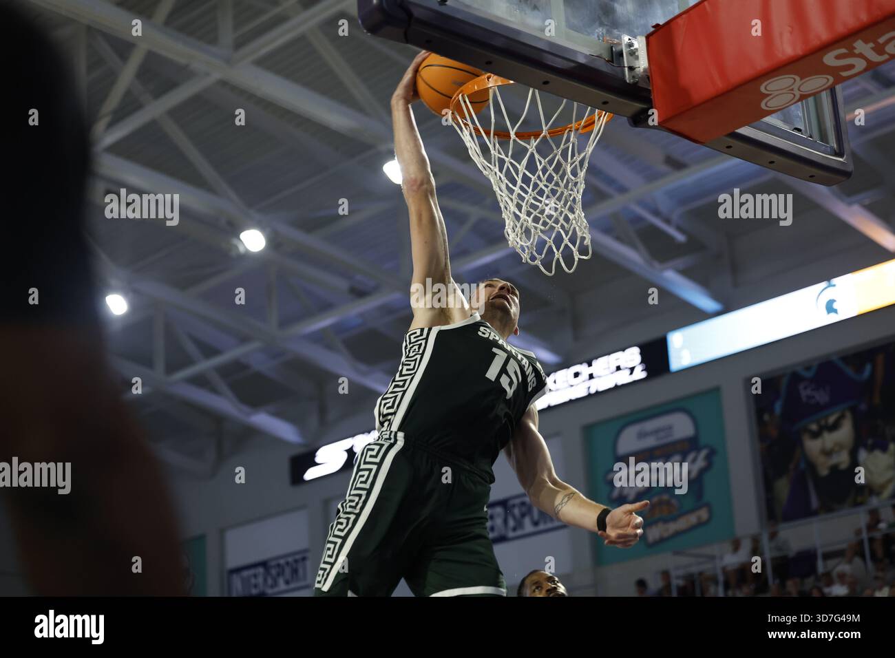 Michigan State center Carson Cooper dunks the ball against East ...