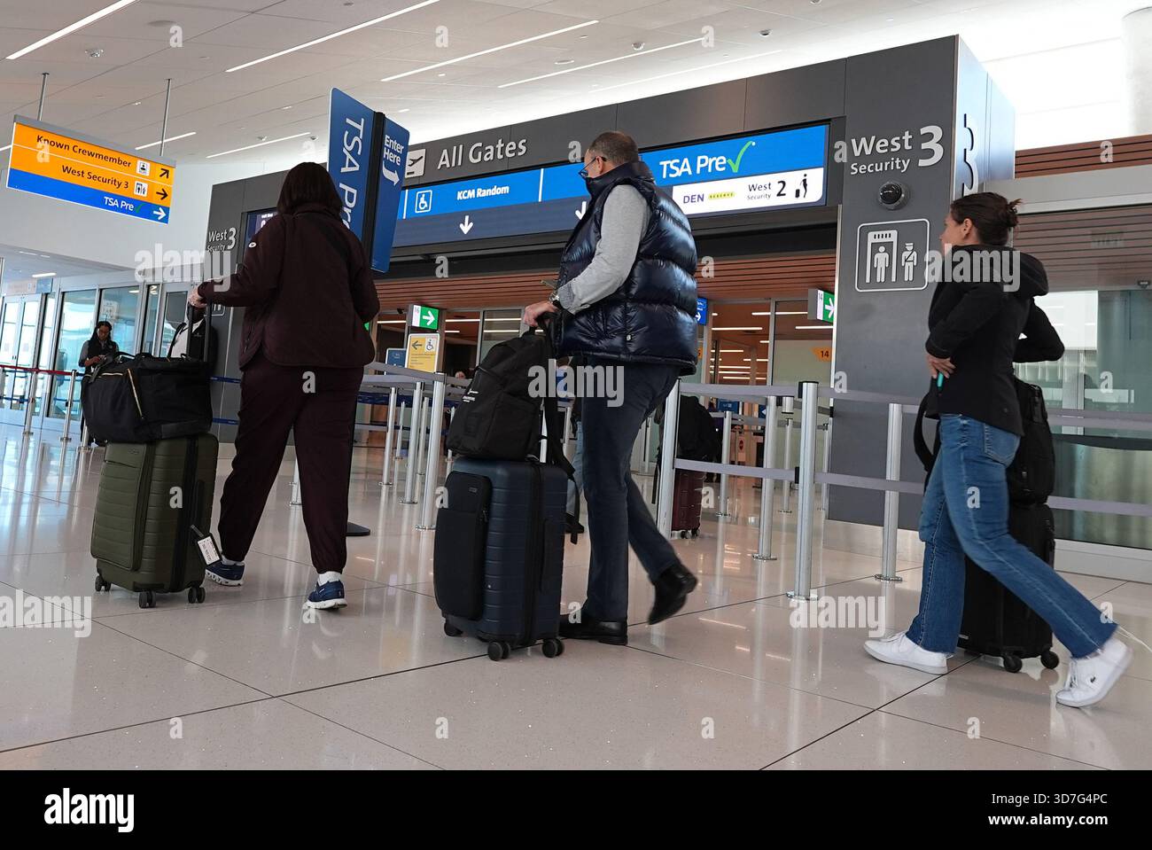 Travelers queue up to pass through the west security checkpoint in the ...