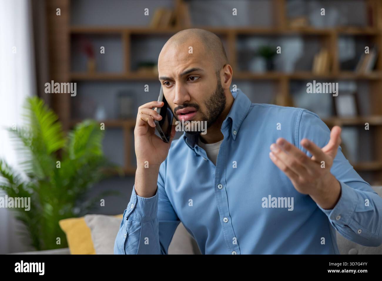 Young man on a mobile phone call receiving bad news, showing stress ...