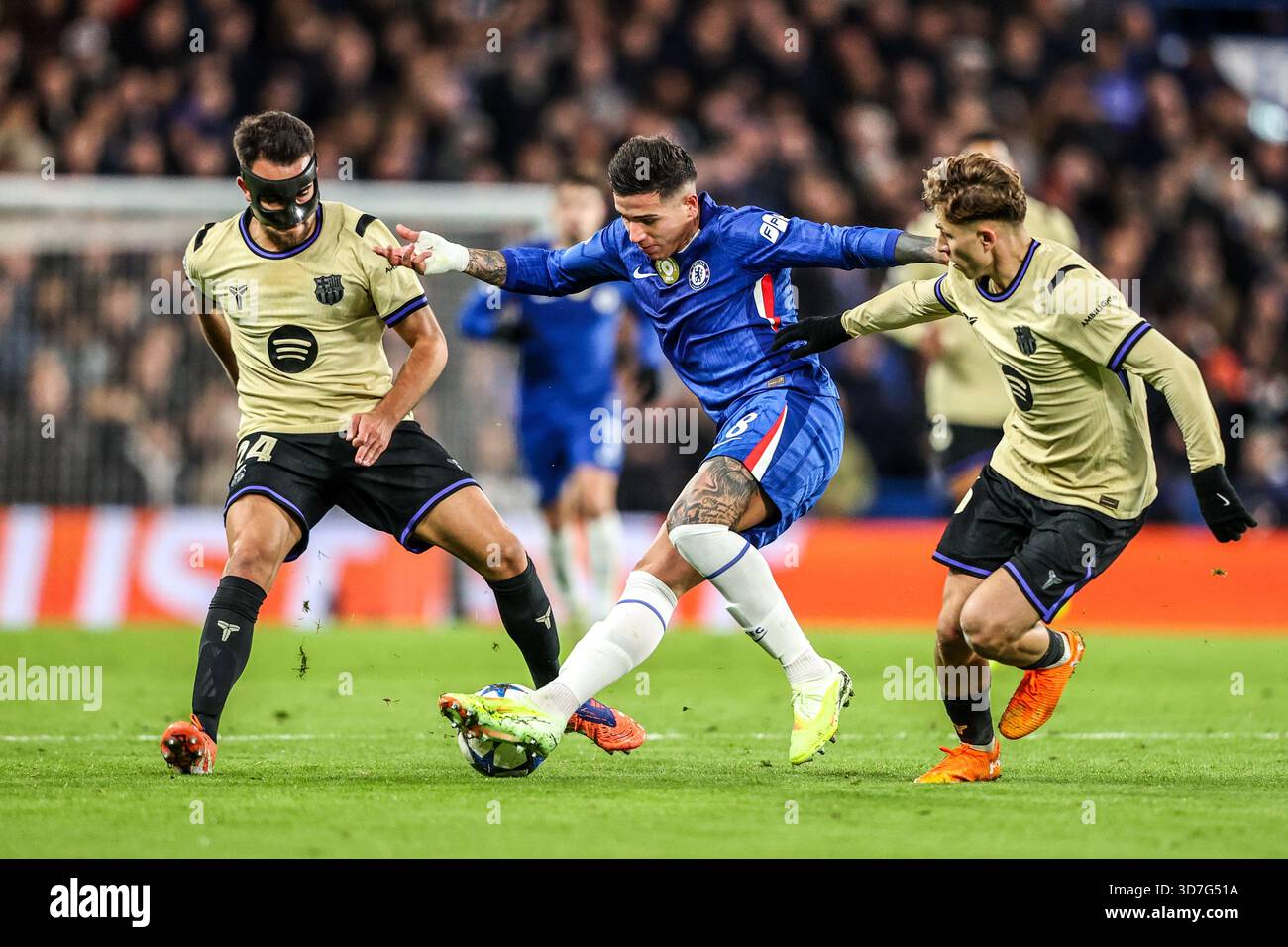 Enzo Fernández of Chelsea holds off Eric Garcia of Barcelona and Fermin ...