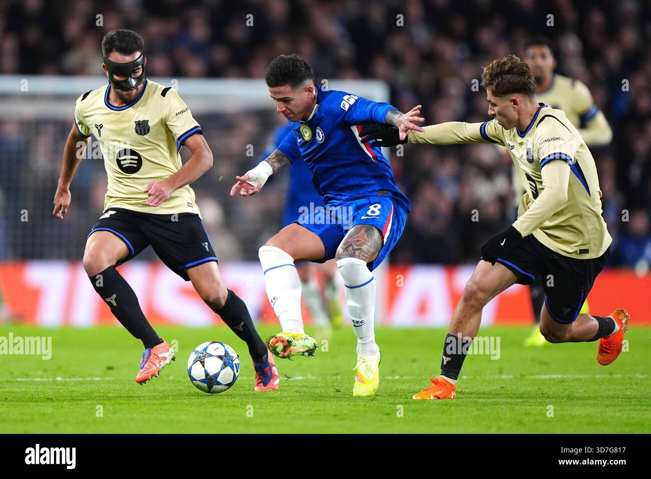 Chelsea's Enzo Fernandez (centre) battles for the ball with Barcelona's ...
