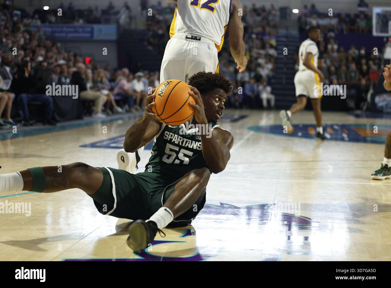 Michigan State center Carson Cooper picks up a loose ball against East ...