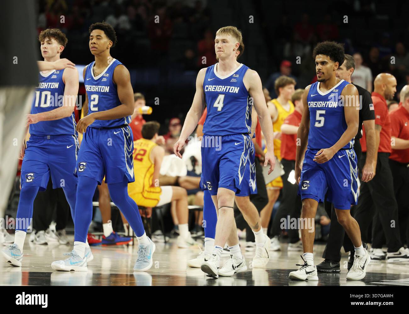 Creighton guard Josh Dix (4) walks to the bench with teammates for a ...