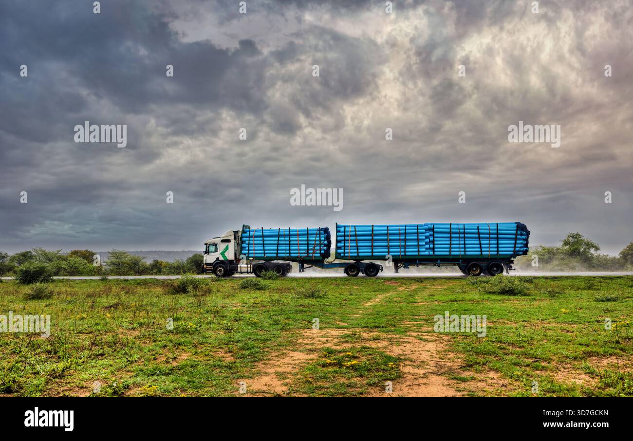 commercial truck hauling a large quantity of plastic pipes on an open ...
