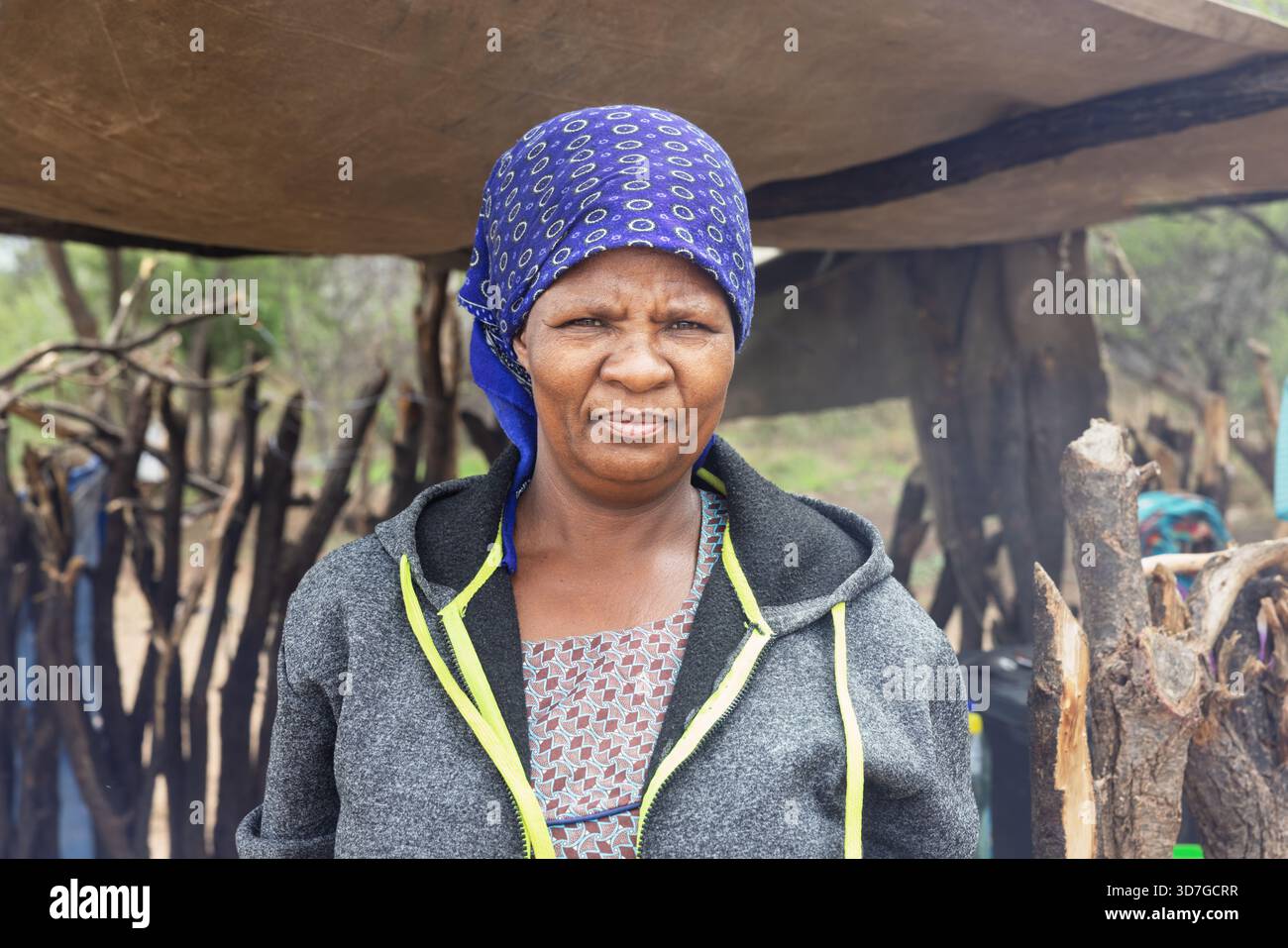 african village woman in front of shack. common in various rural ...