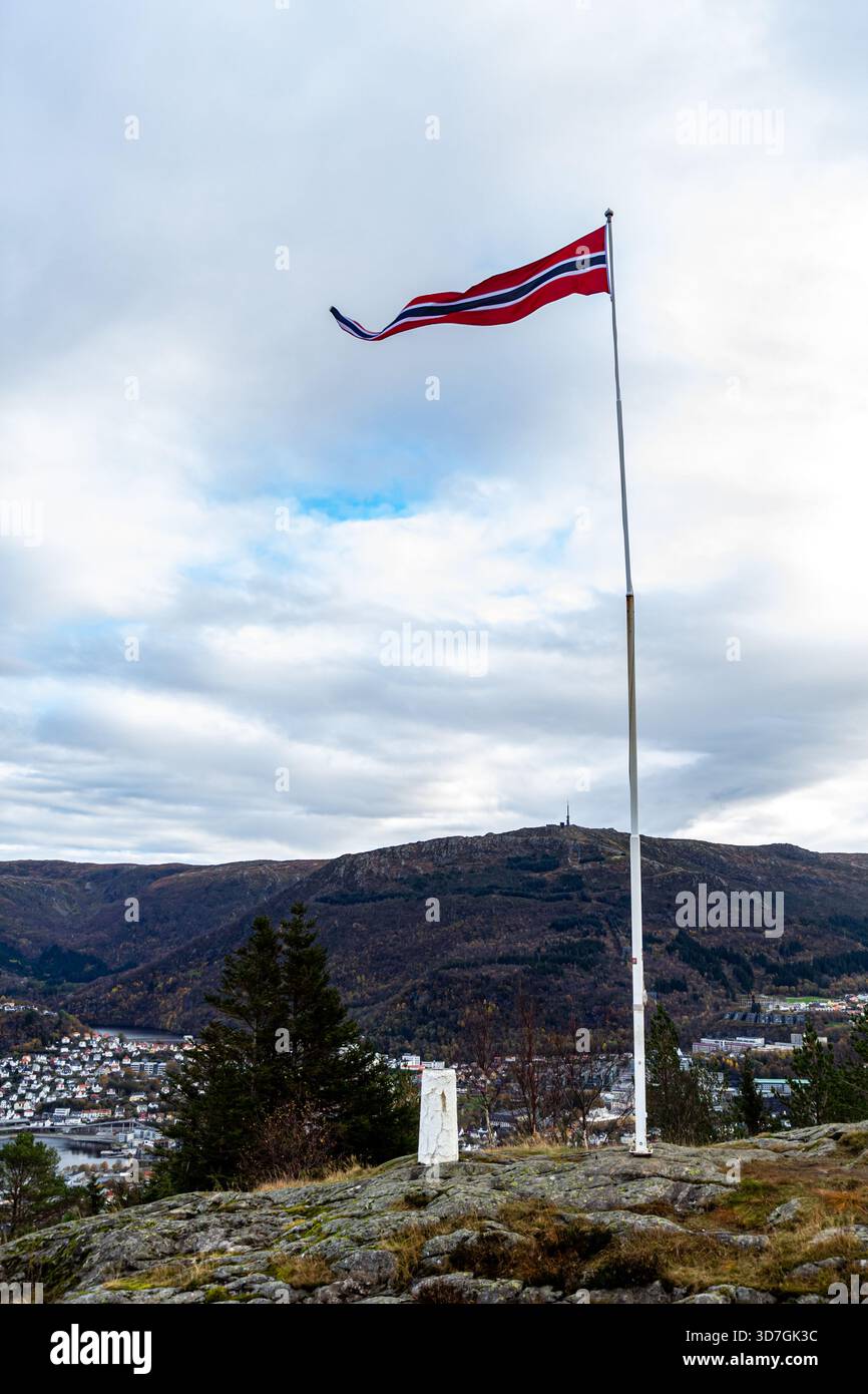 Norwegian vimpel flag waving on a Bergen mountain peak, with soft white ...