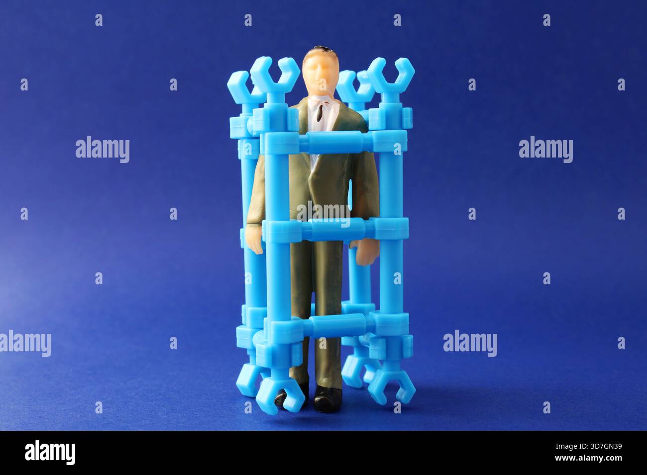 Executive trapped by a structure made of plastic pieces, structured ...