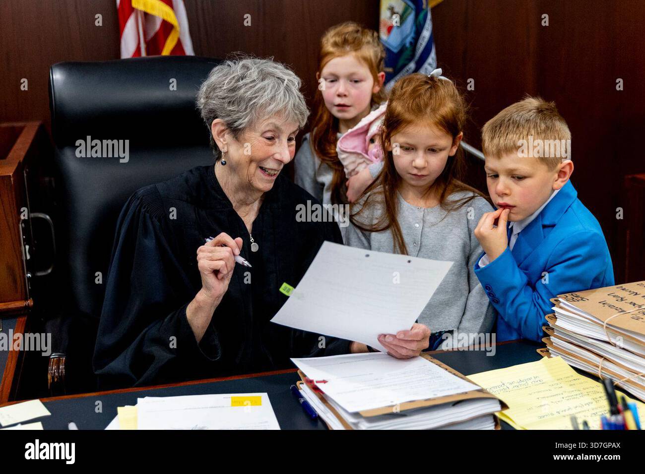 Ruth, Cheyenne and Thomas Moon look over the paperwork with Genesee ...