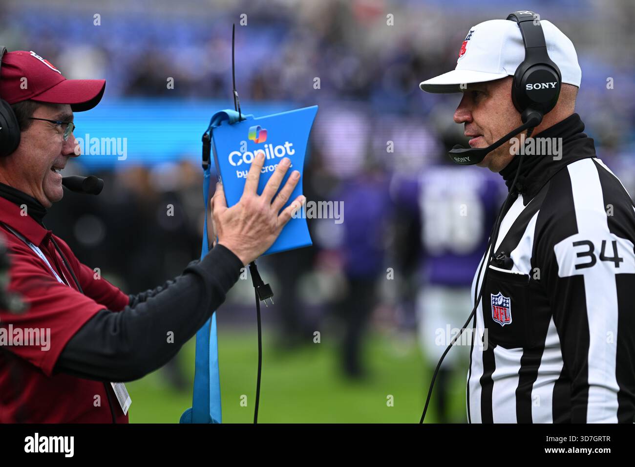 NFL referee Clete Blakeman (34) checks an instant replay monitor warms ...
