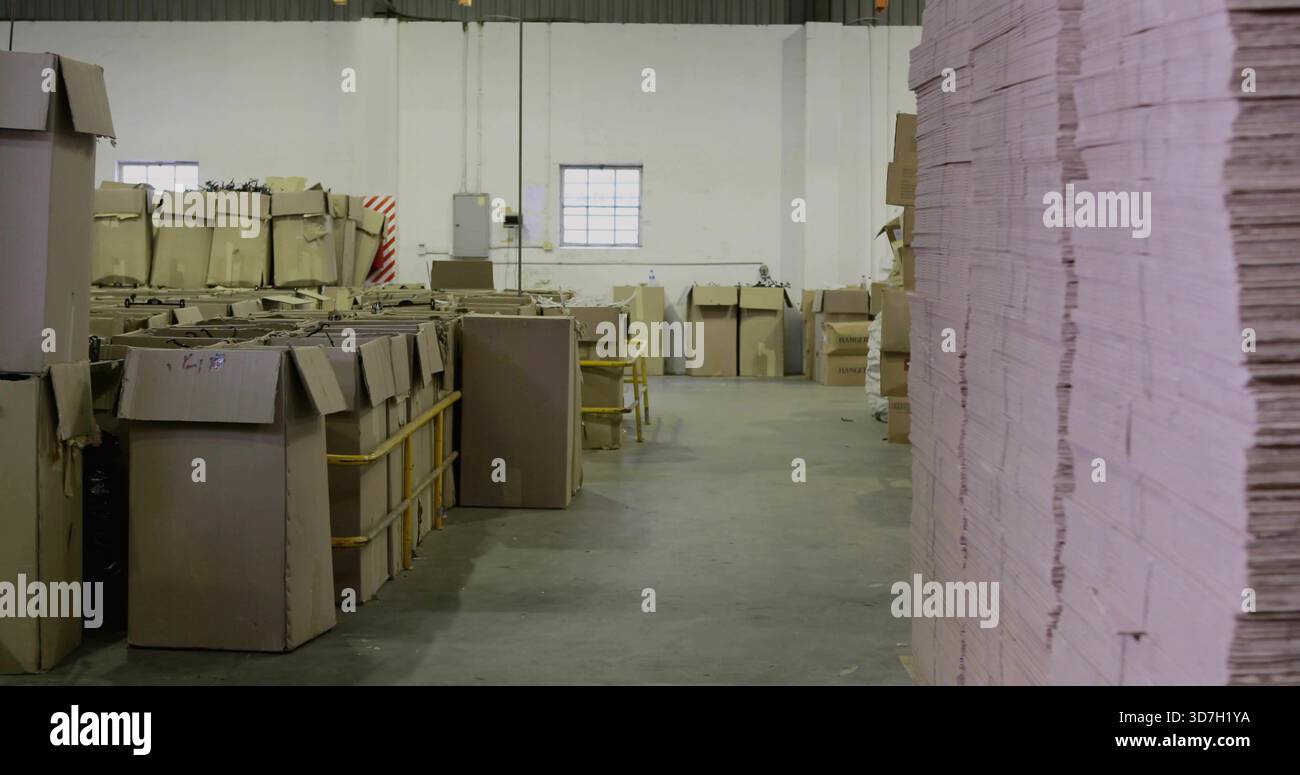 Filling right side tall stack flat cardboard sheets in warehouse aisle ...
