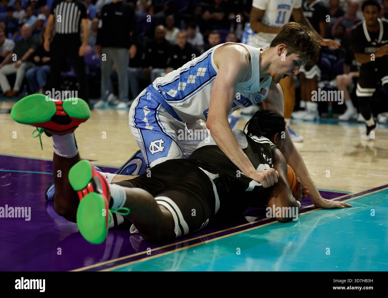 North Carolina center Henri Veesaar wrestles for a loose ball with St ...