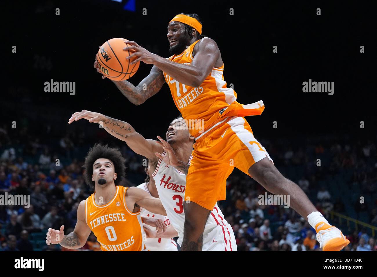Tennessee guard Amaree Abram (77) grabs a rebound over Houston guard ...