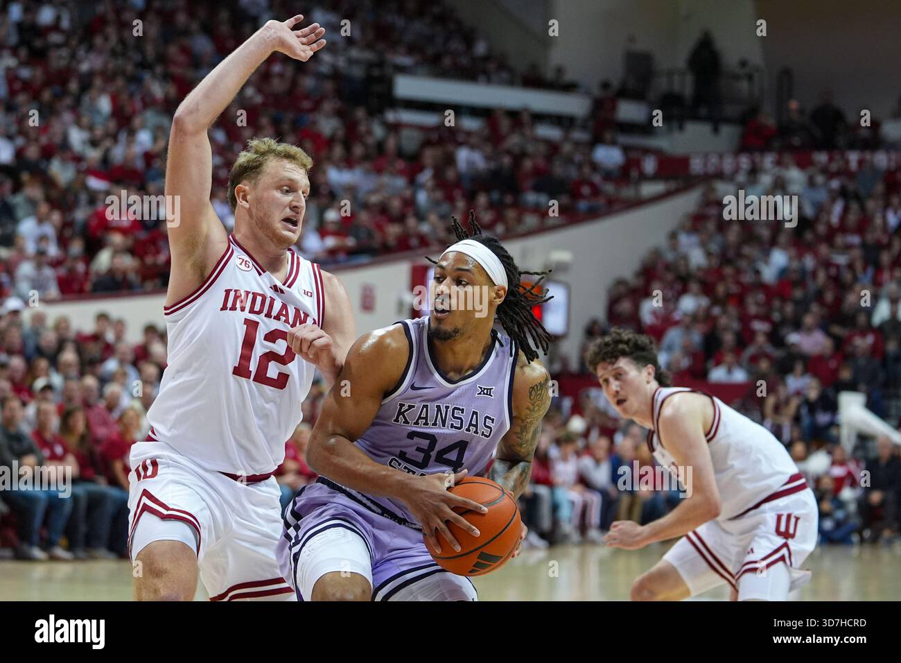 Kansas State guard Nate Johnson (34) looks to shoot over Indiana forward Tucker Devries (12) in ...