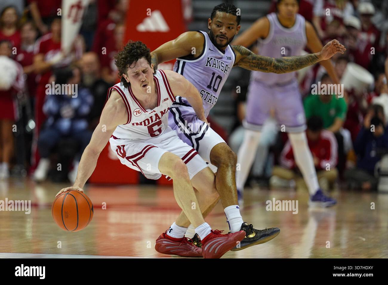 Indiana guard Conor Enright (5) gets tangled up with Kansas State guard ...