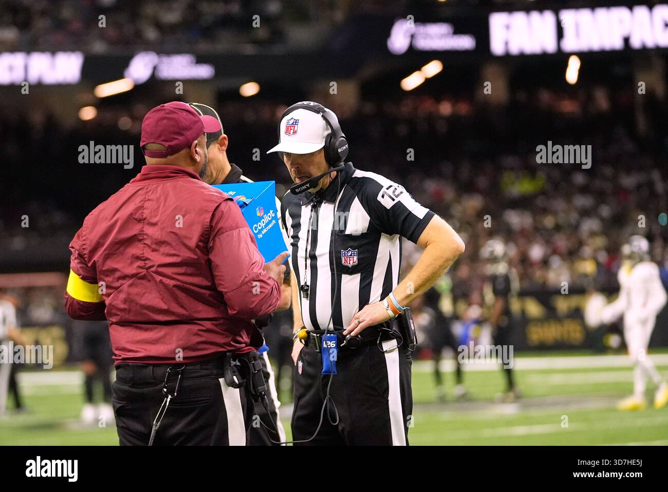A head referee reviews a play in the first half of an NFL football game ...