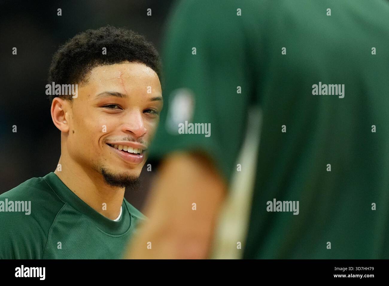 Milwaukee Bucks' Ryan Rollins smiles as he warms up before an NBA ...