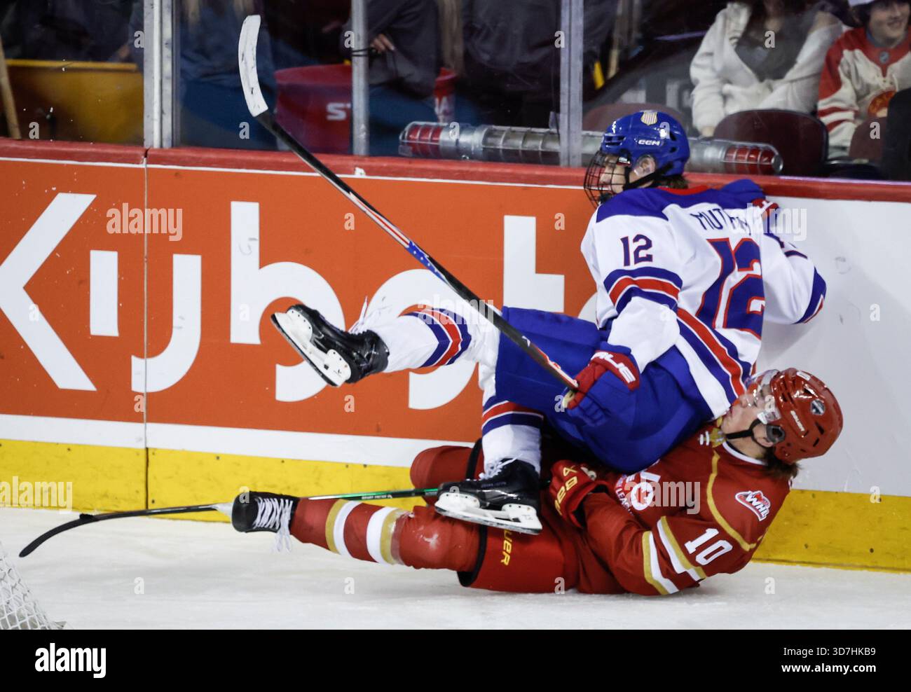 Team USA's Casey Mutryn, top, checks Team CHL's Daxon Rudolph during ...