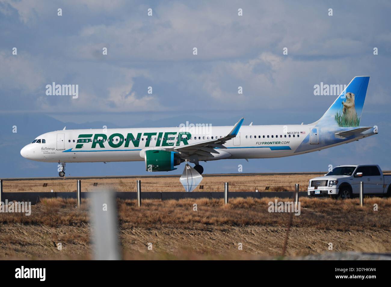 Frontier Airlines jetliner taxis down a runway for take off from Denver ...