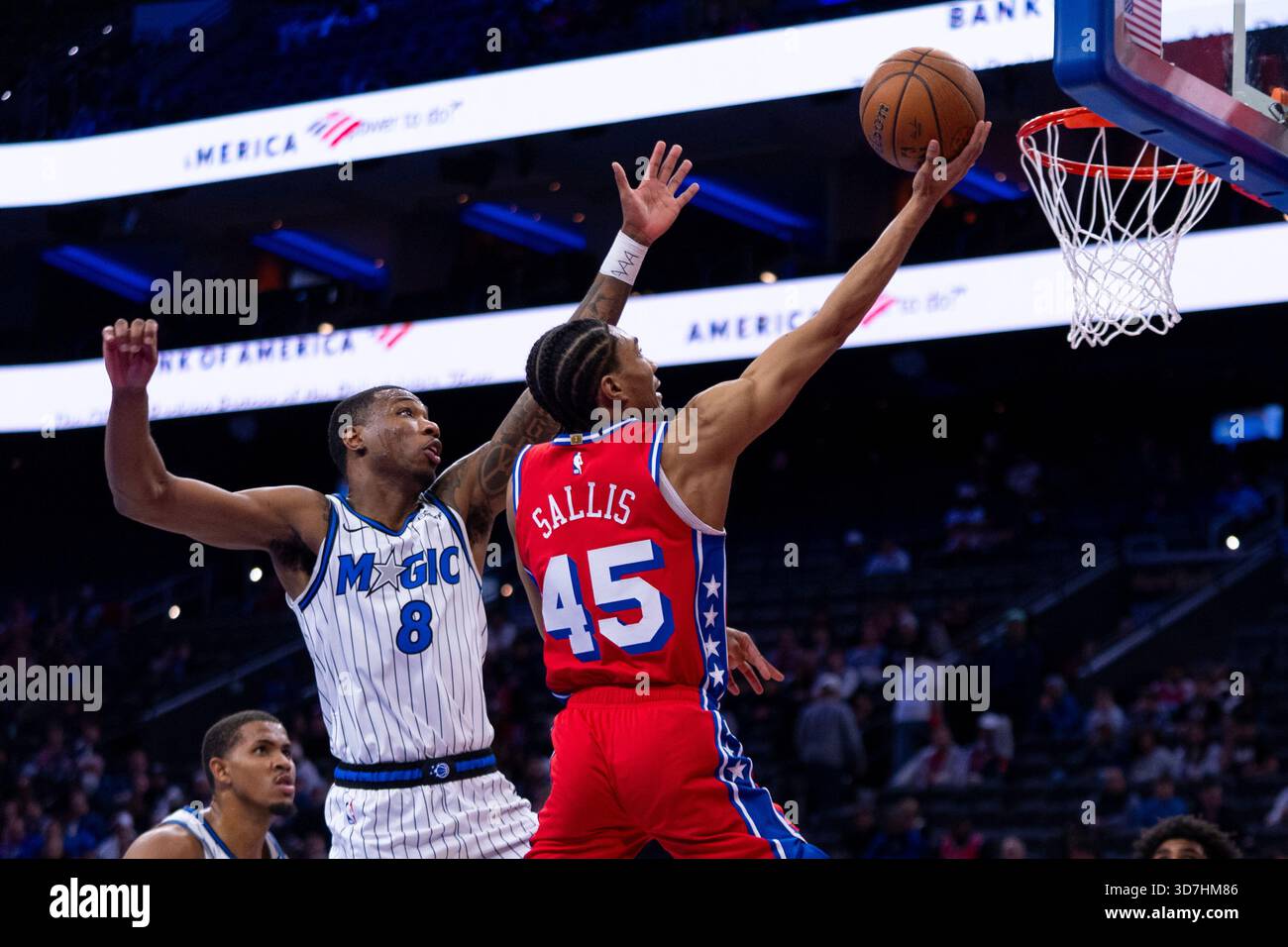 Philadelphia 76ers' Hunter Sallis, right, goes up for the shot against ...