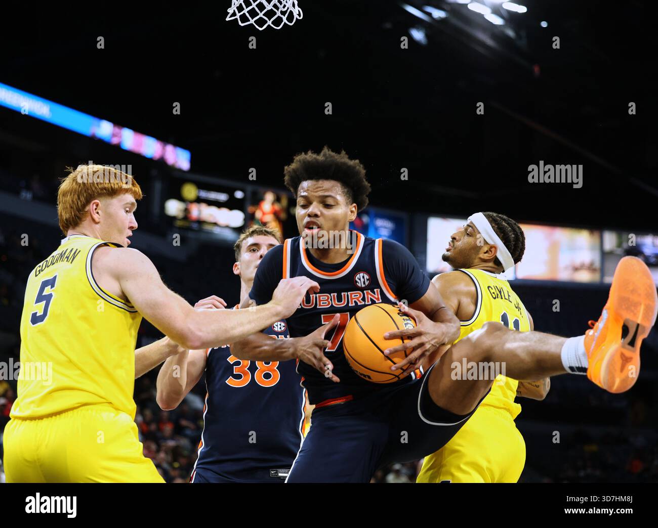 Auburn guard Keyshawn Hall (7) grabs a rebound near Michigan forward ...