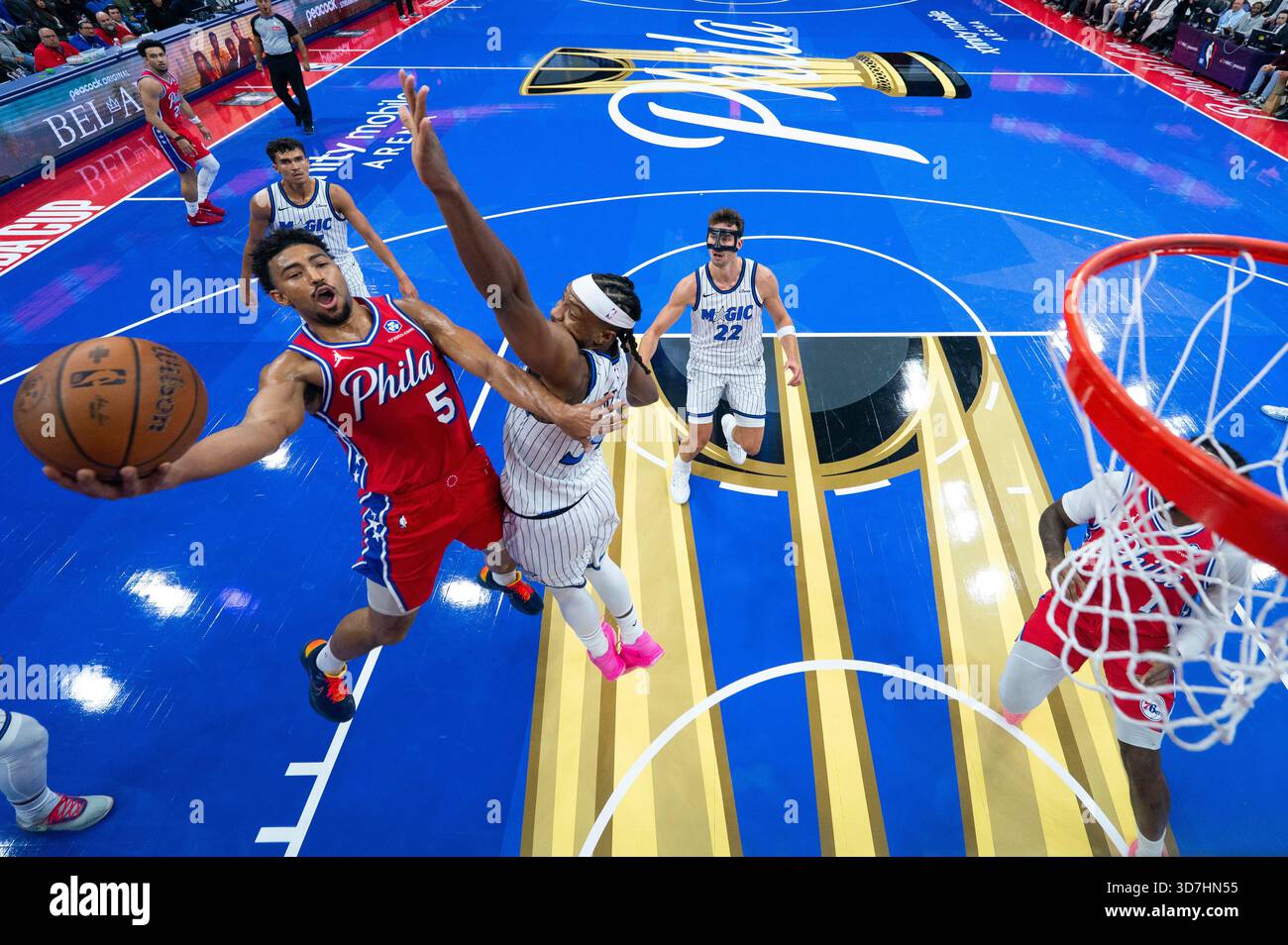Philadelphia 76ers' Quentin Grimes, left, goes up for the shot against ...