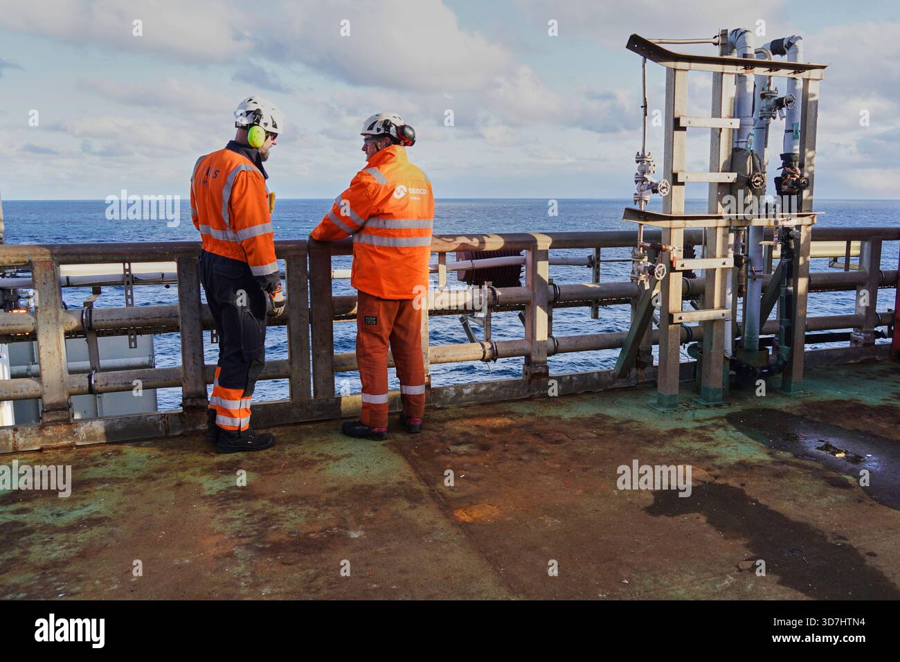 Workers stand at the platform's railing on the INEOS Energy's Siri ...